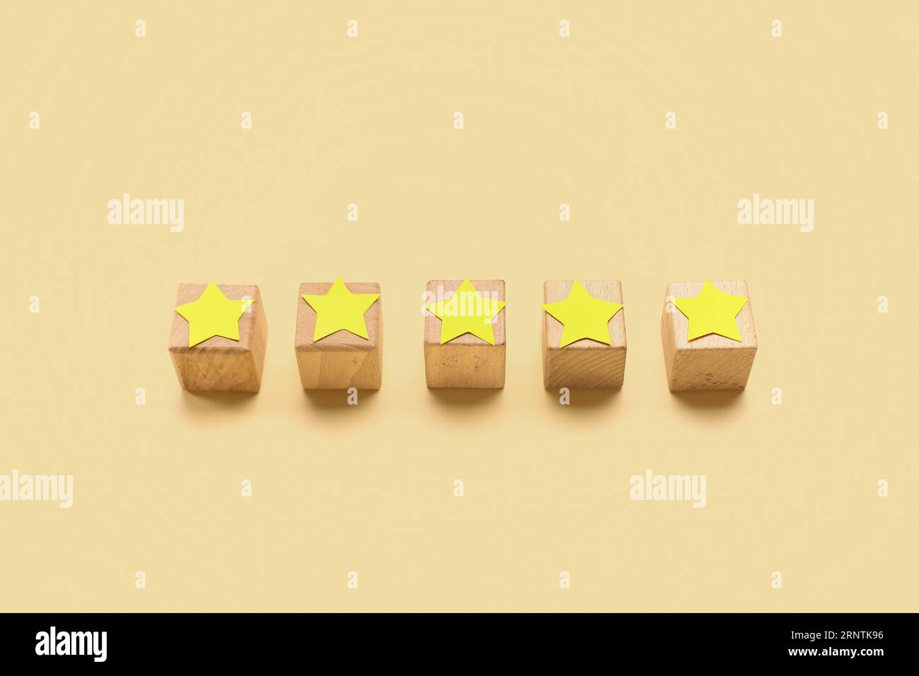 Five cubes with stars on beige background. Customer experience concept ...