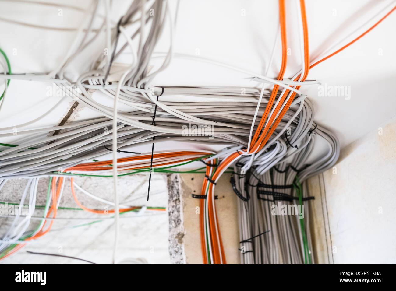 Electric cable on the ceiling of a flat, electrical installation of a ...
