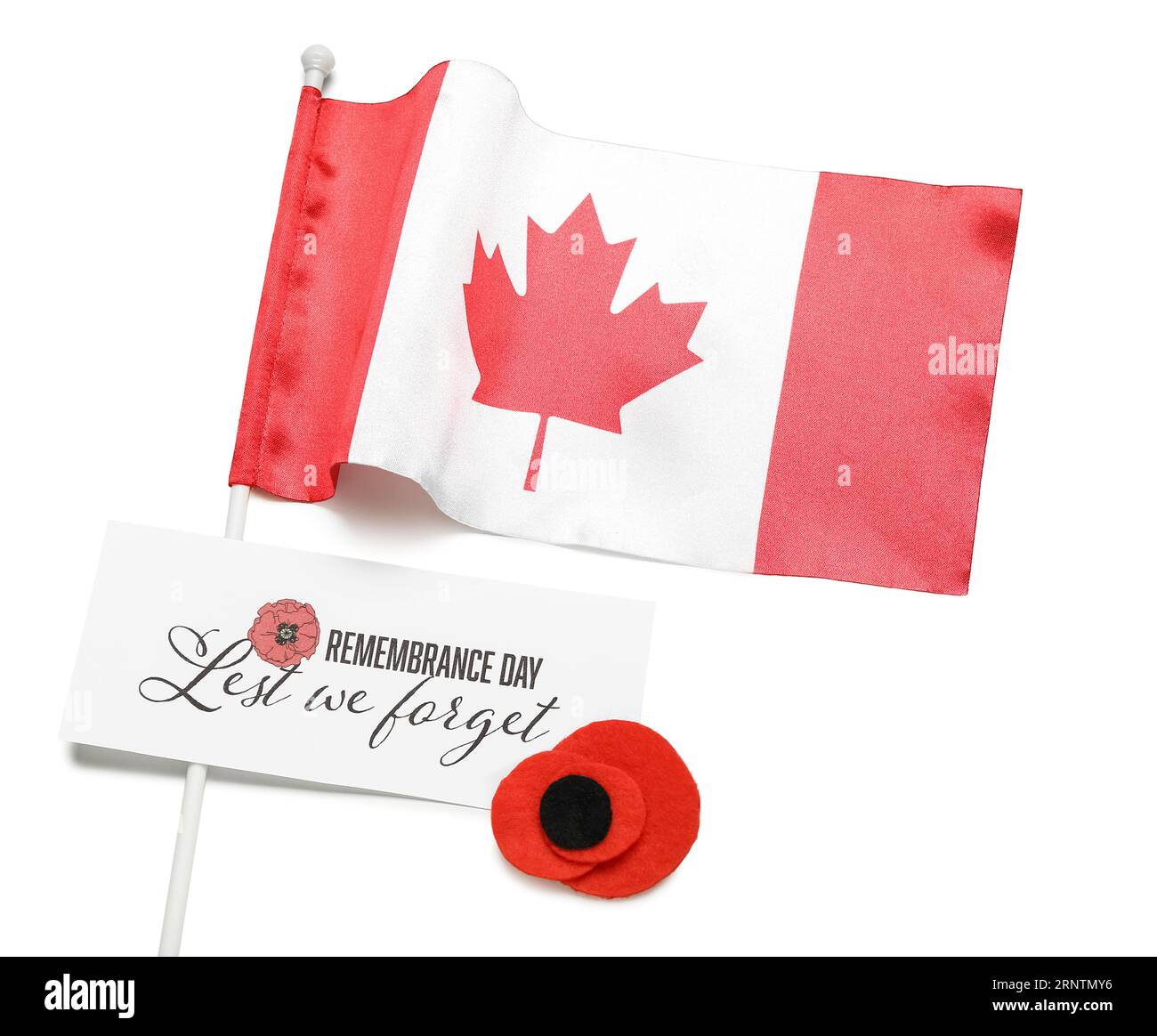 Poppy flower, flag of Canada and card with text LEST WE FORGET on white ...