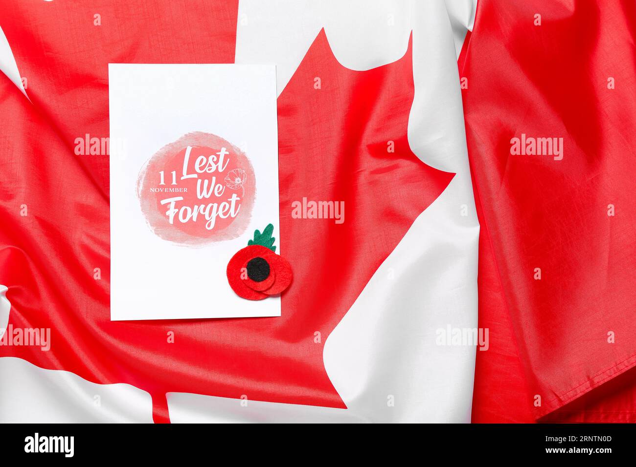 Poppy flower and card on flag of Canada as background. Remembrance Day ...