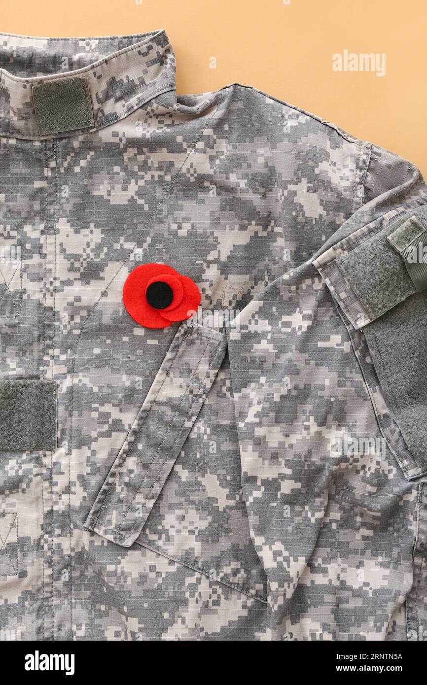 Poppy flower with military uniform on orange background. Remembrance ...
