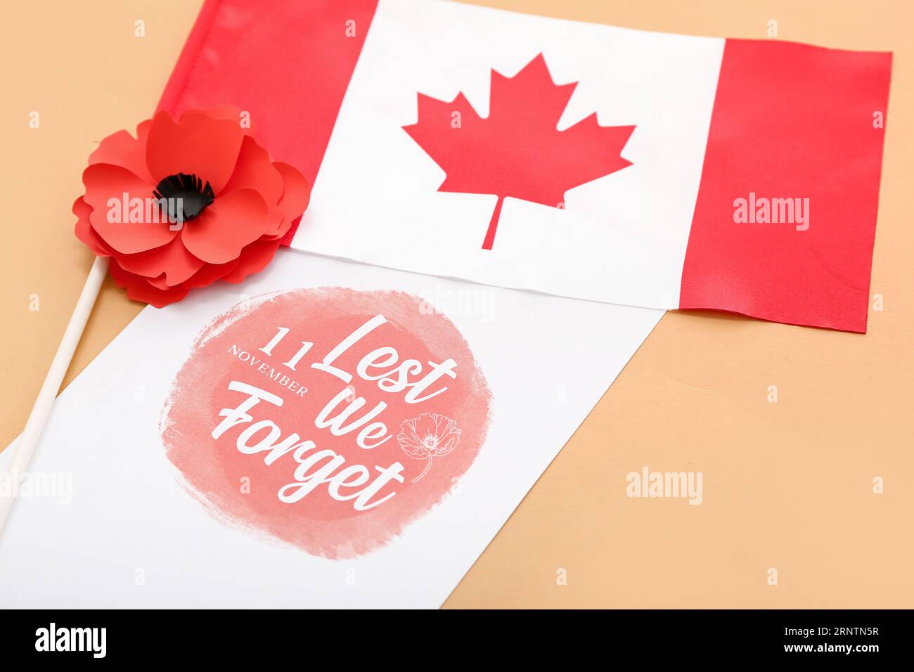 Poppy flower, flag of Canada and card with text LEST WE FORGET on ...