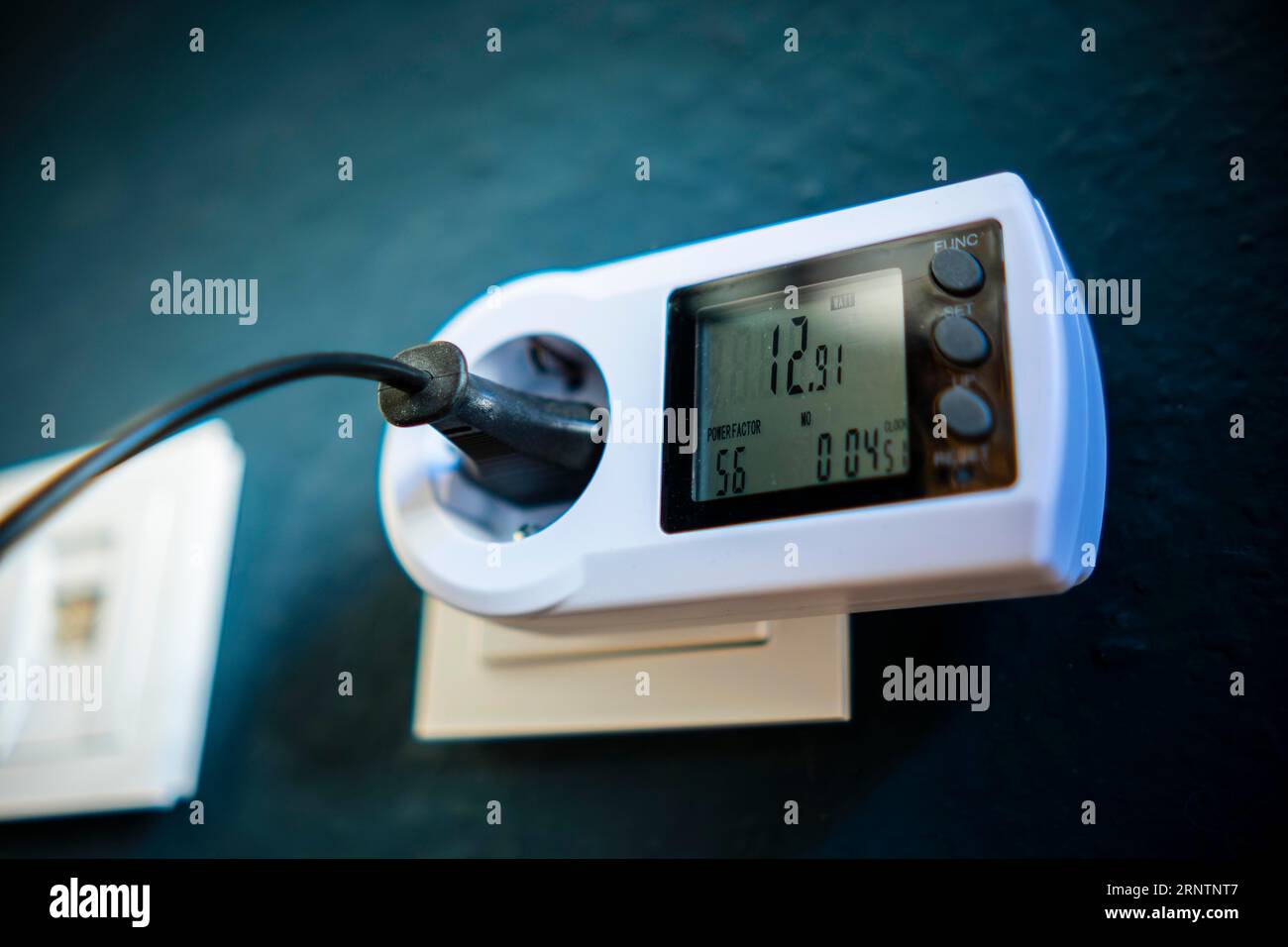 Measuring device for recording the power consumption at a socket outlet Stock Photo - Alamy