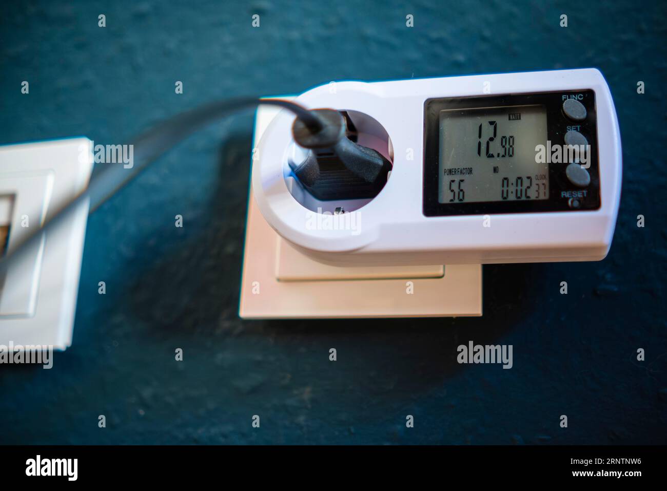 Measuring device for recording the power consumption at a socket outlet Stock Photo - Alamy
