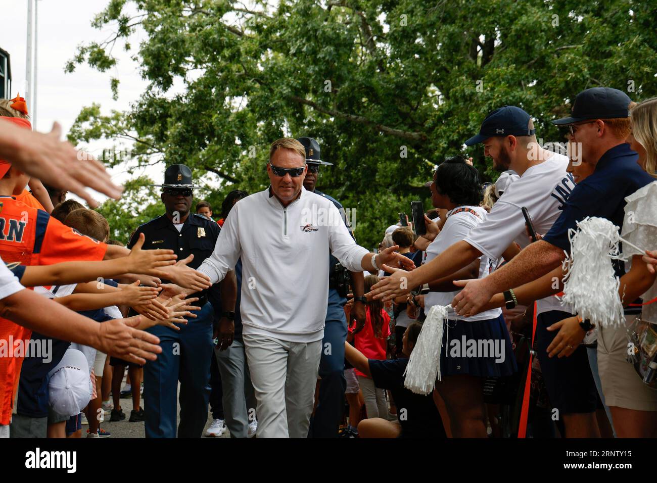 Auburn head coach Hugh Freeze greets fans as he walks to the stadium in ...