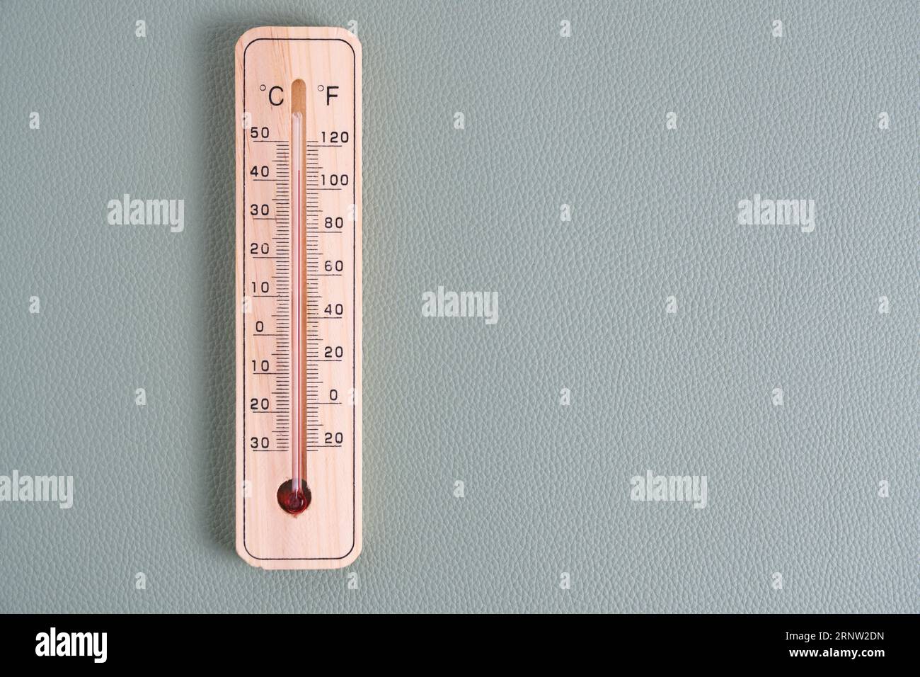 Wooden outdoor thermometer green background Stock Photo - Alamy