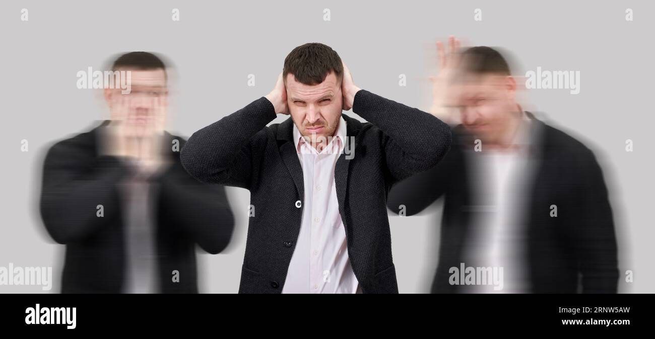 Man in focus expressing frustration surrounded by blurred figures ...