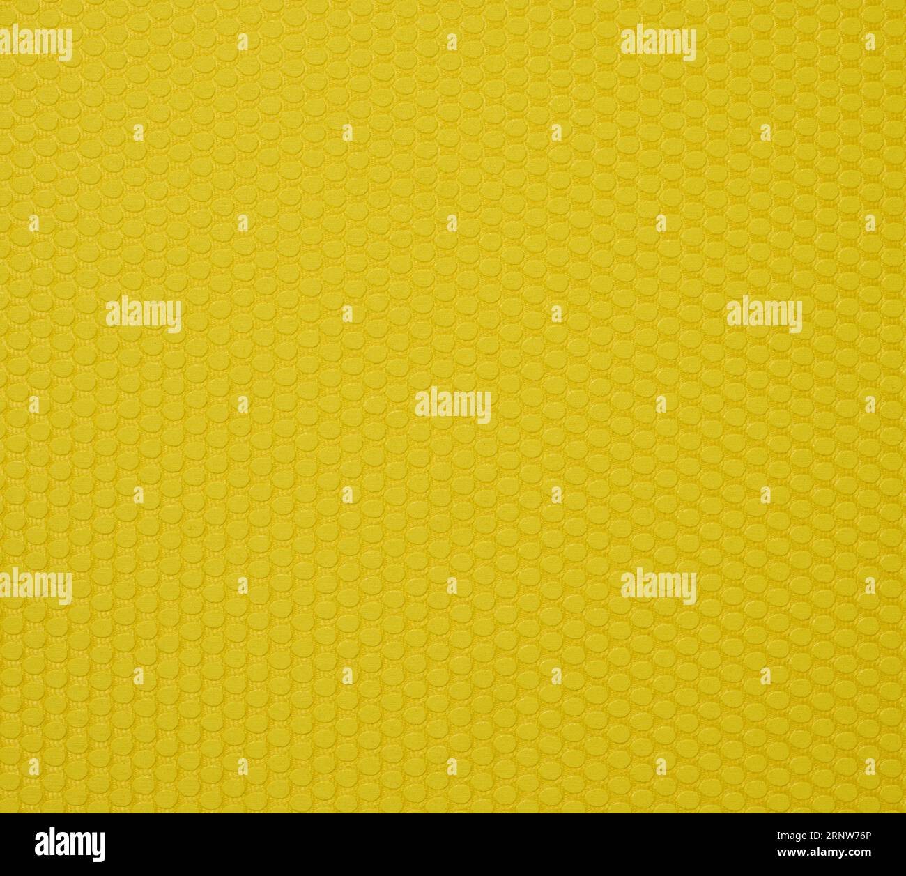 A yellow background texture made up of small hexagons that are slightly ...