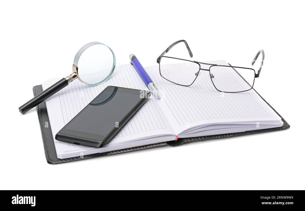 Notebook, glasses, cell phone and magnifying glass isolated on white ...