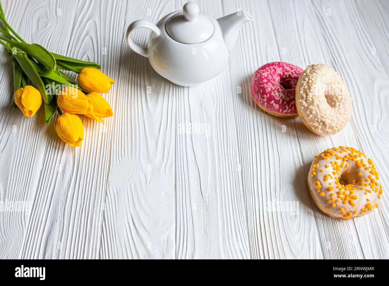 Breakfast for Mother's Day or March 8. Colorful doughnuts, a teapot and ...
