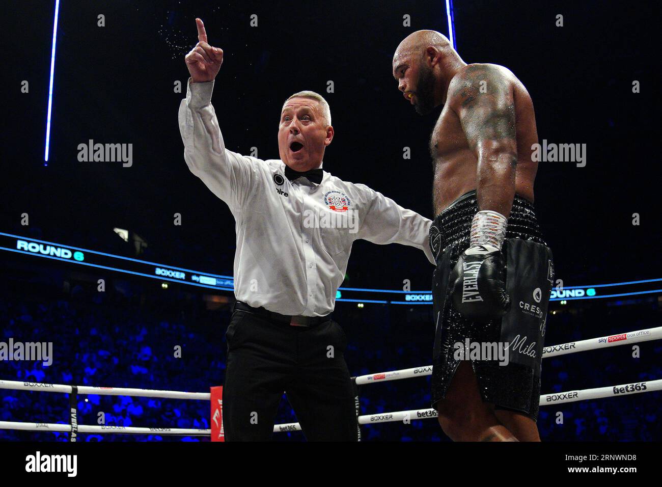 Ring referee speaks to Frazer Clarke (right) after landing a low blow ...
