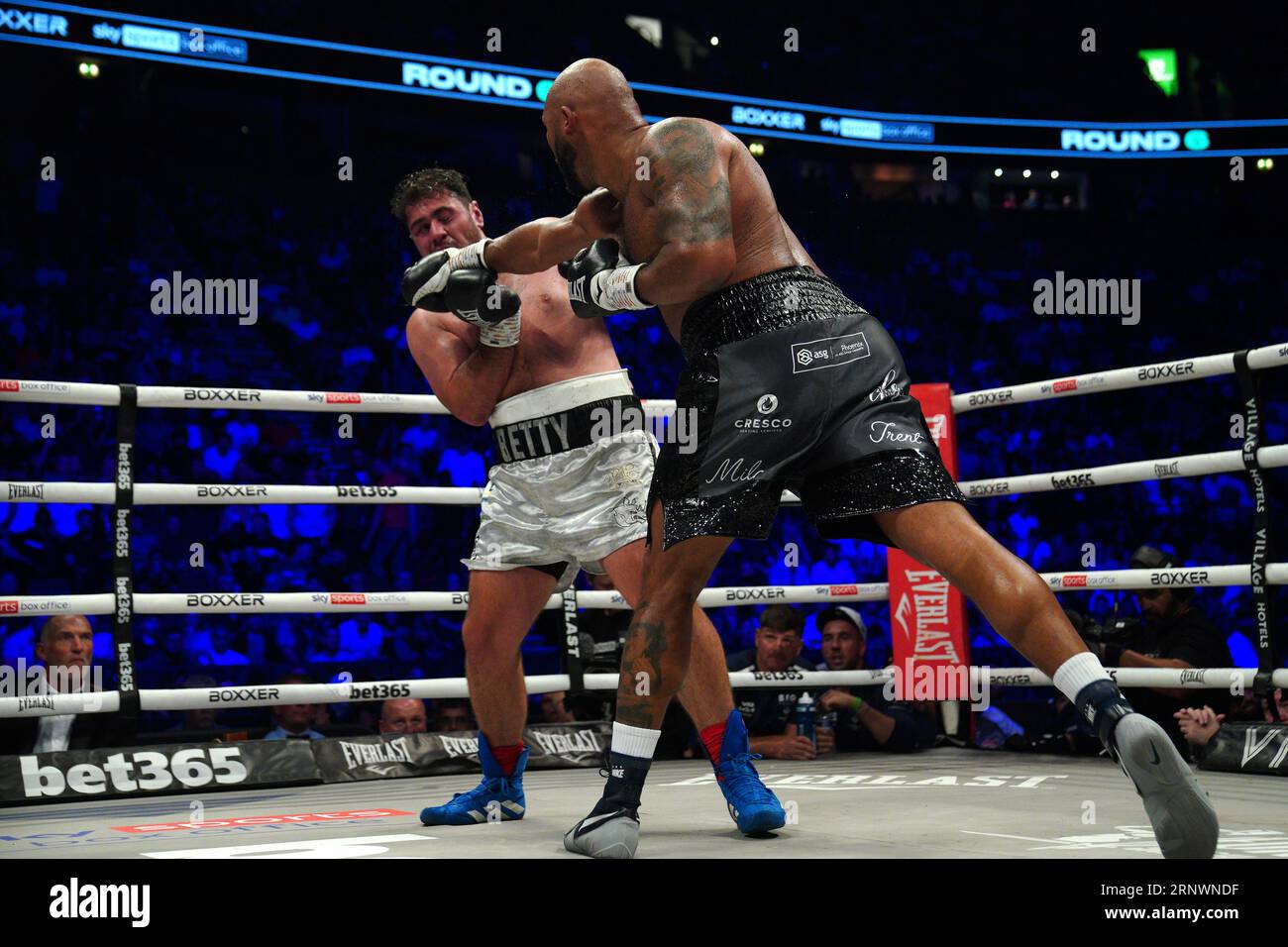 Frazer Clarke (right) strikes David Allen in the heavyweight bout at ...