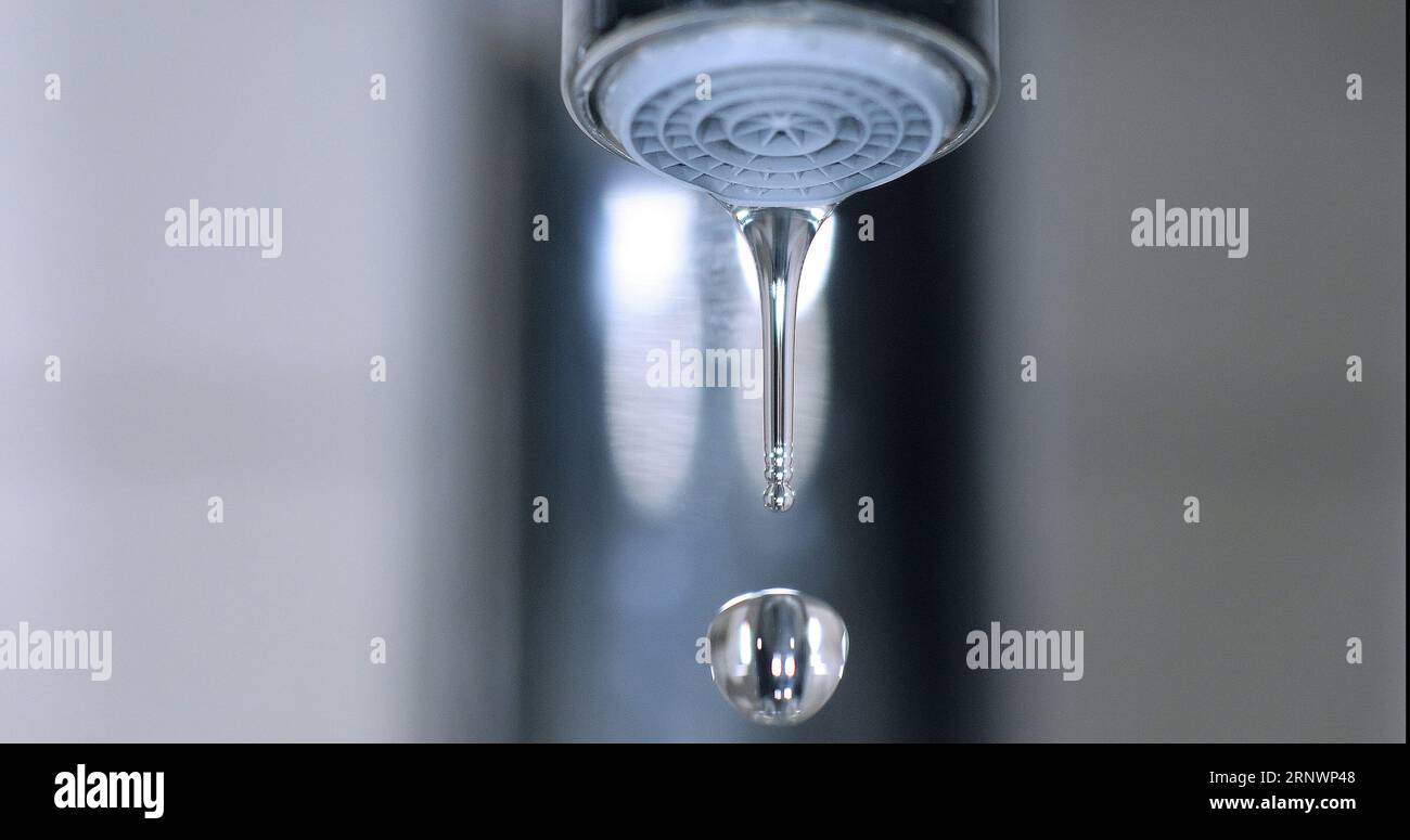 Water Flowing from the Tap, making a drop of water Stock Photo - Alamy