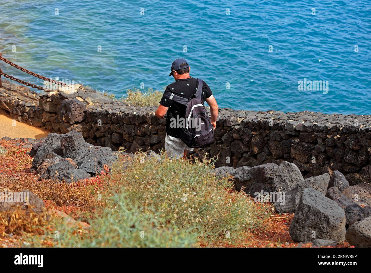 Man walking on path between Playa Blanca and Las Coloradas, Lanzarote ...