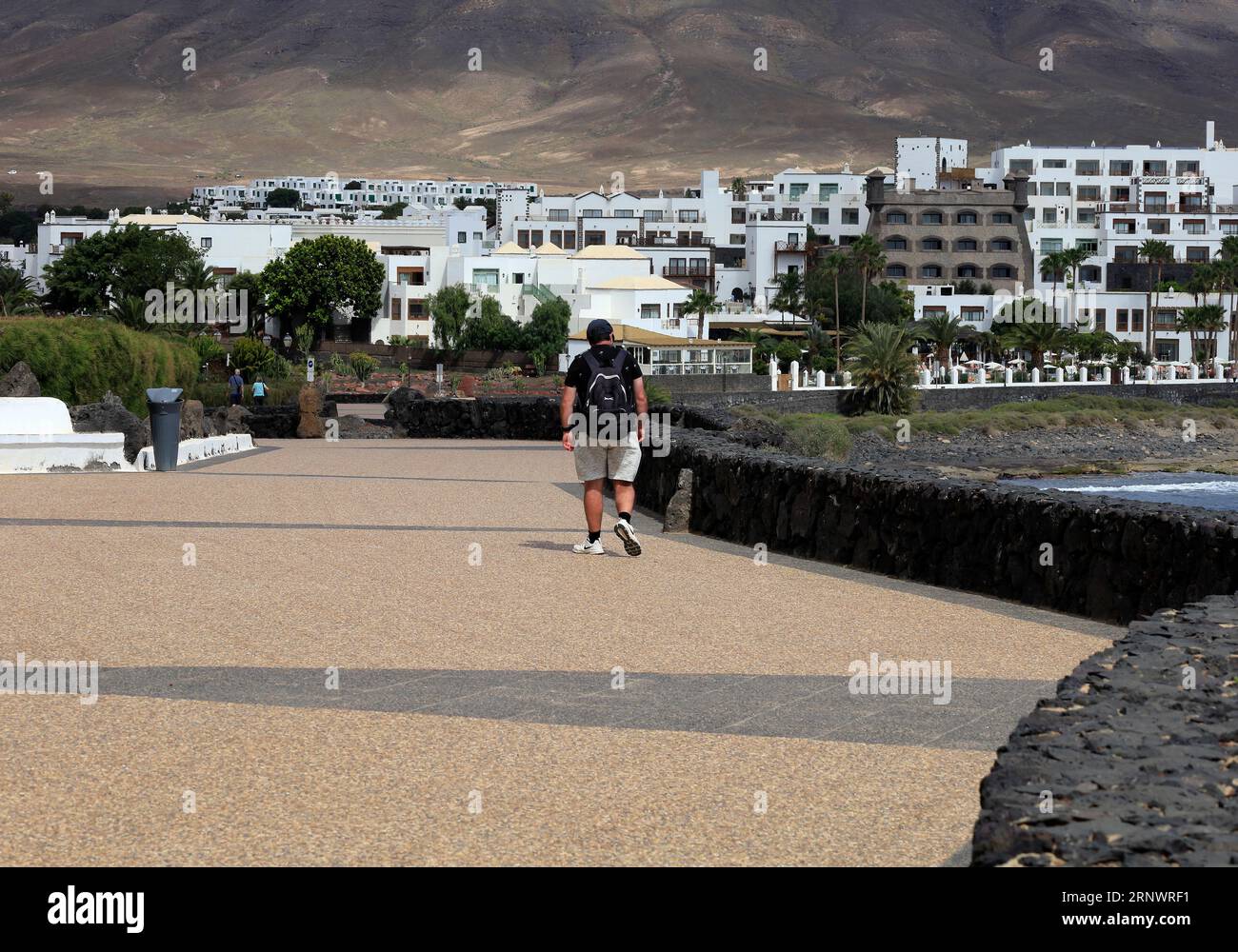 Man walking on path between Playa Blanca and Las Coloradas, Lanzarote ...