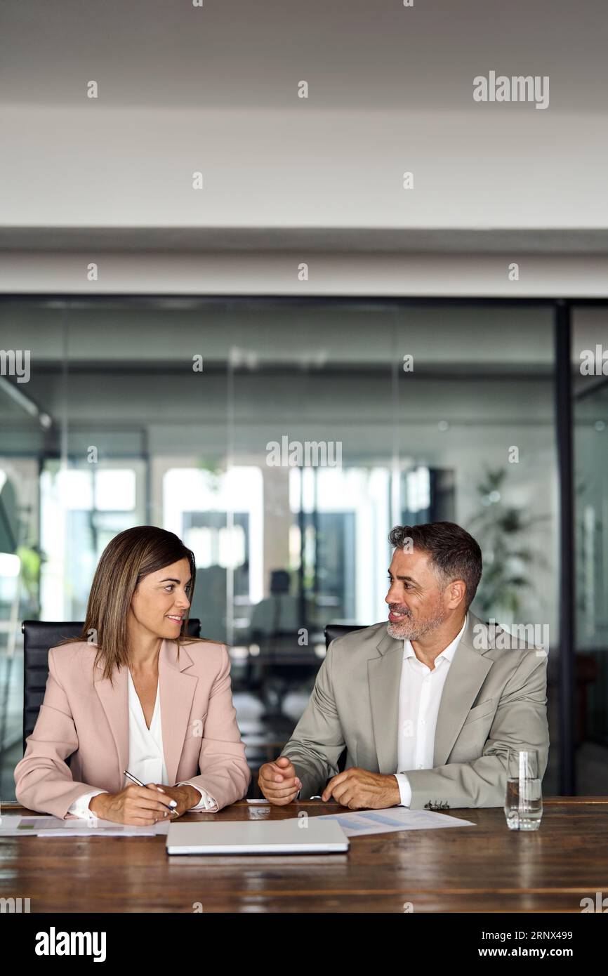 Two executive managers working and taking at meeting in office ...