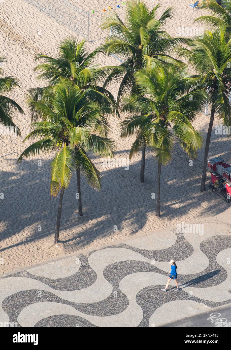 Rio de Janeiro, Brazil: a woman walking on the iconic graphic sidewalk ...