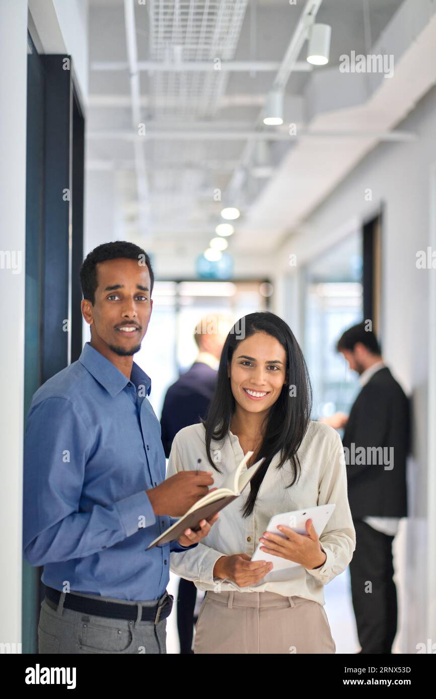 Happy diverse office workers standing in office hallway, vertical ...