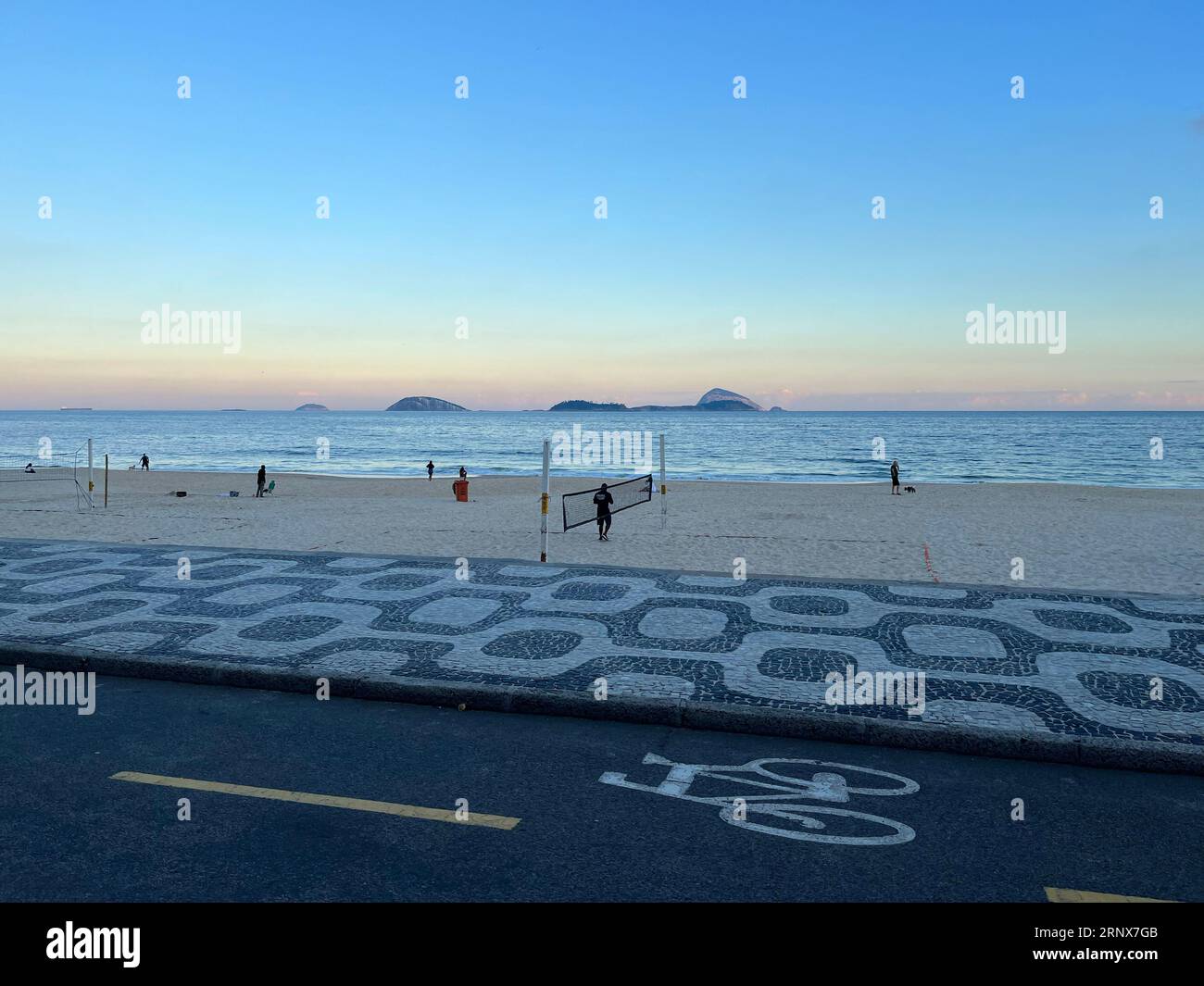 Rio de Janeiro, Brazil: people playing at sunset on Ipanema beach with ...