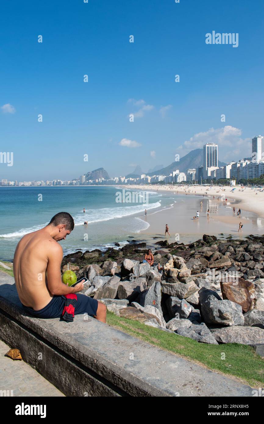 Rio de Janeiro, Brazil: boy looking his smartphone in front of the ...