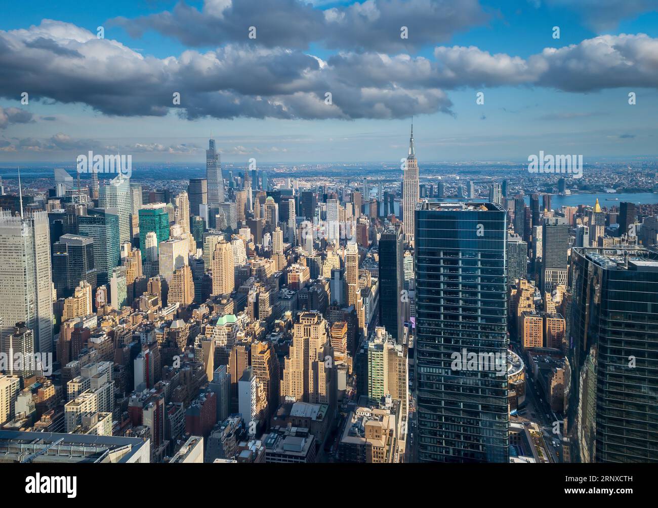 An arial view of Midtown Manhattan New York City. The sky is blue and ...