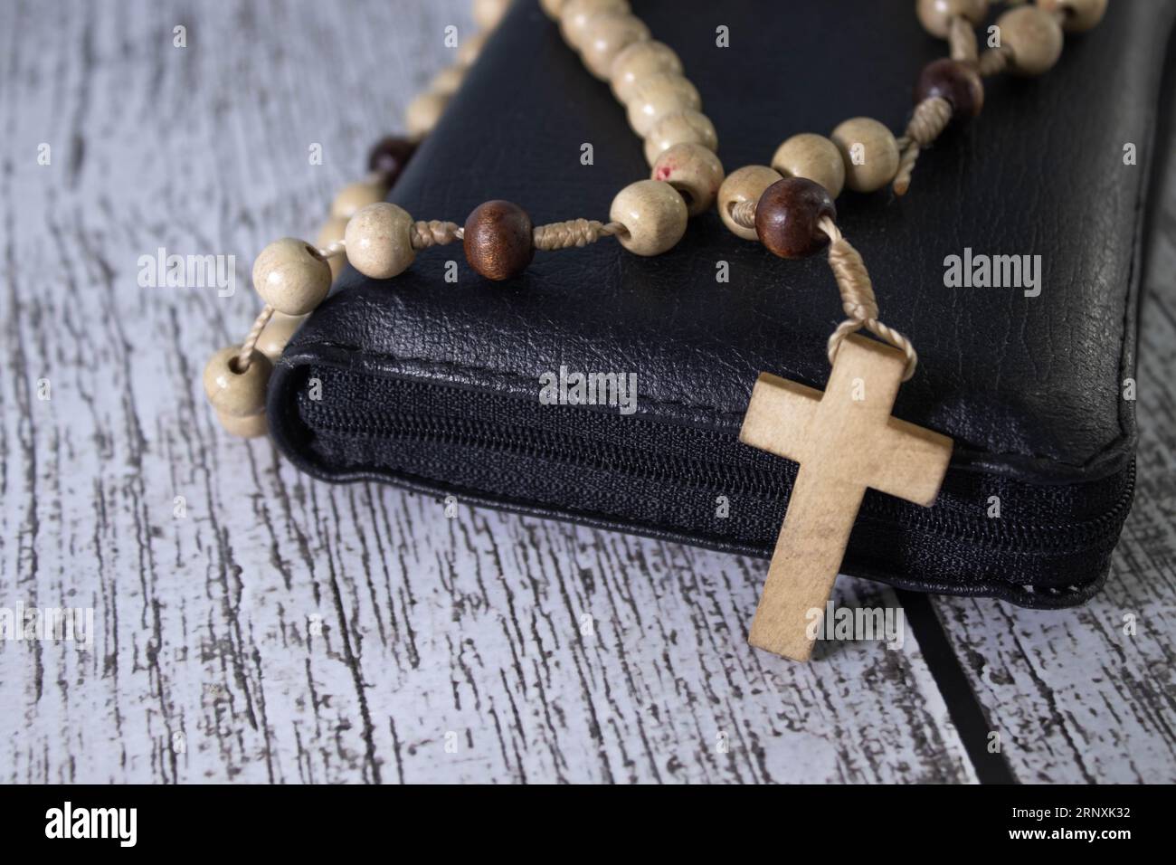 Christian wooden crucifix on open bible, point focus. Religious concept ...