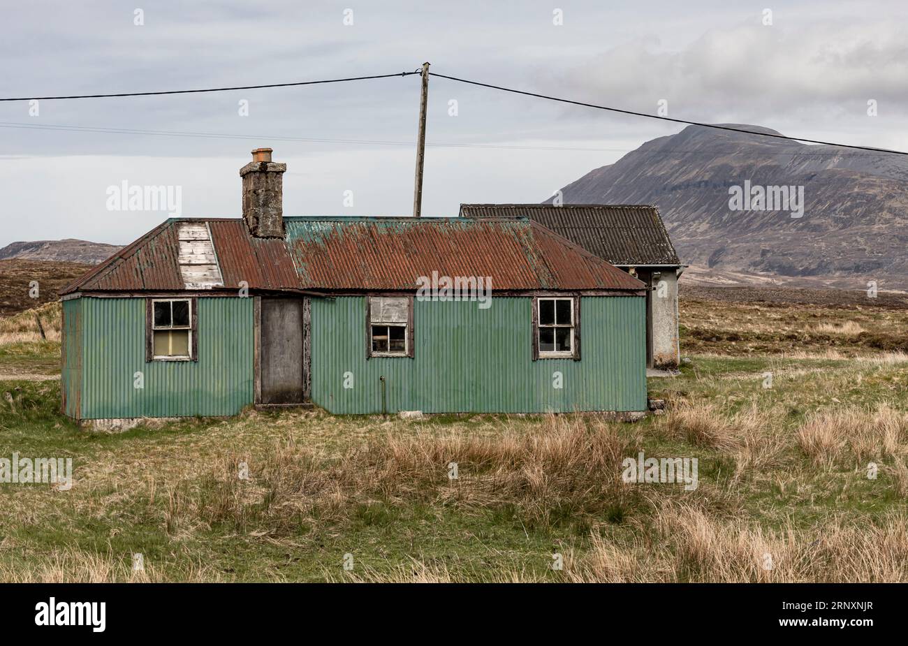 Old house made of corrugated iron sheets with green walls and a red ...