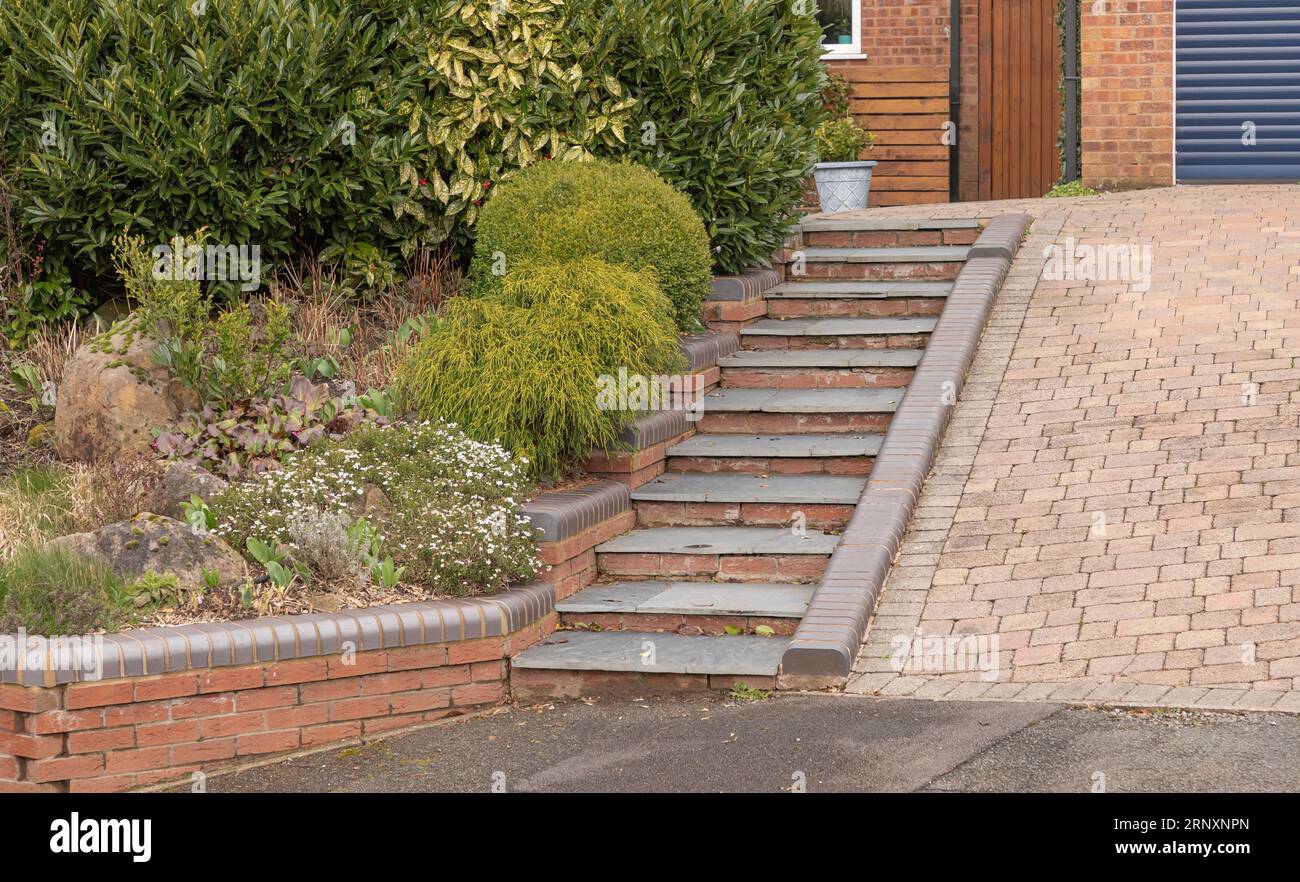 Slope coming down from a house with steps and a rockery garden Stock ...