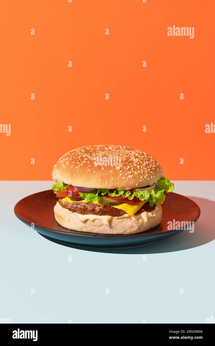 Classic traditional cheeseburger with beef, tomato, lettuce, pickles ...