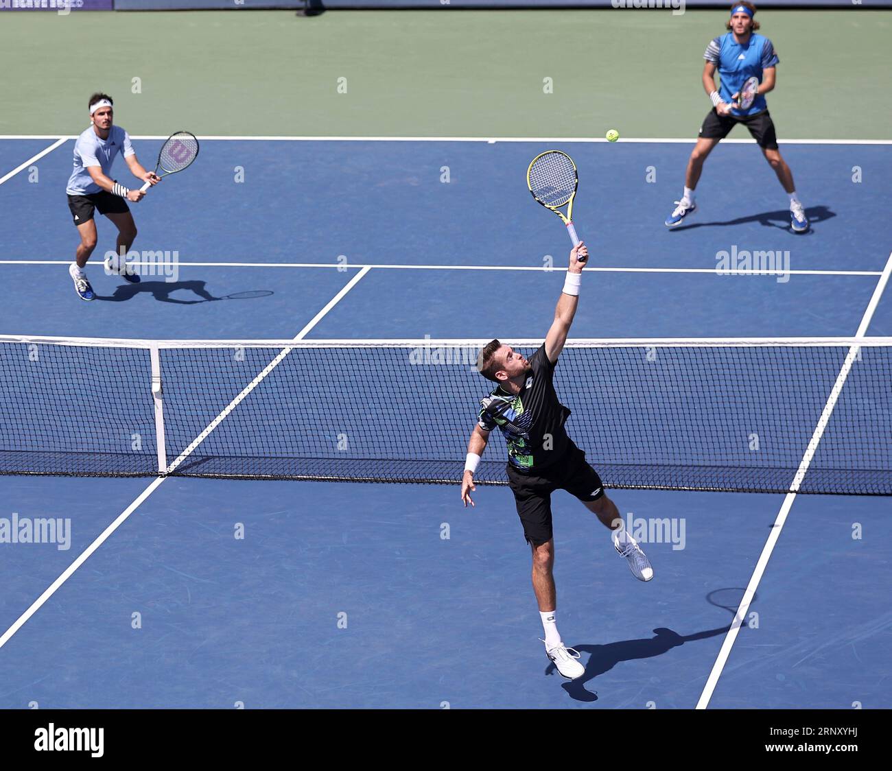 Austin Krajicek in action during a men's doubles match with Ivan Dodig ...
