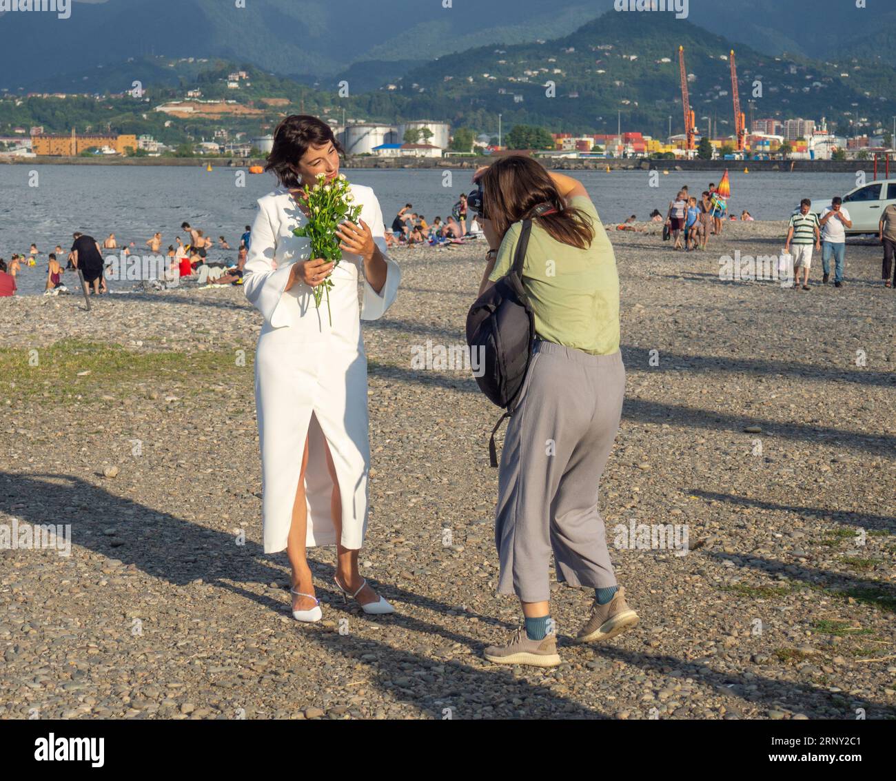 Batumi, Georgia. 08.24.2023 Photographer at work. The girl takes a ...