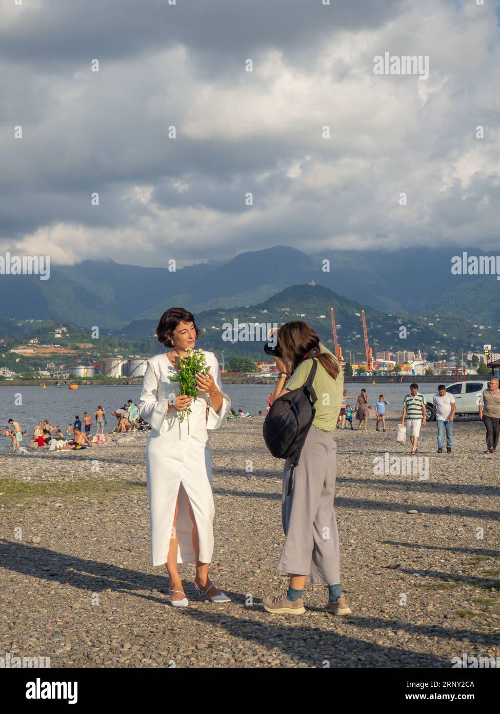Batumi, Georgia. 08.24.2023 Photographer at work. The girl takes a ...