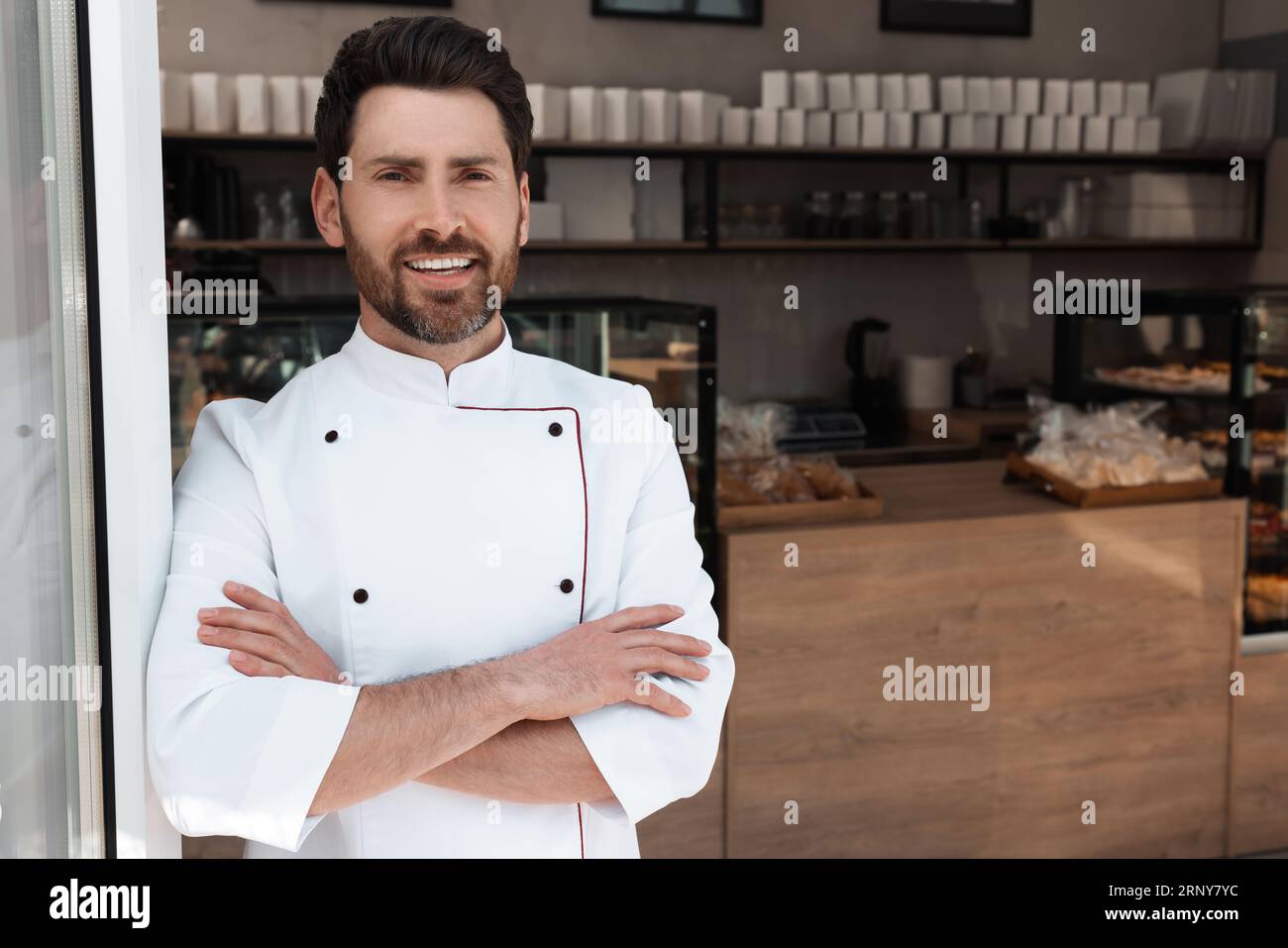 Portrait of professional baker in bakery shop. Space for text Stock ...