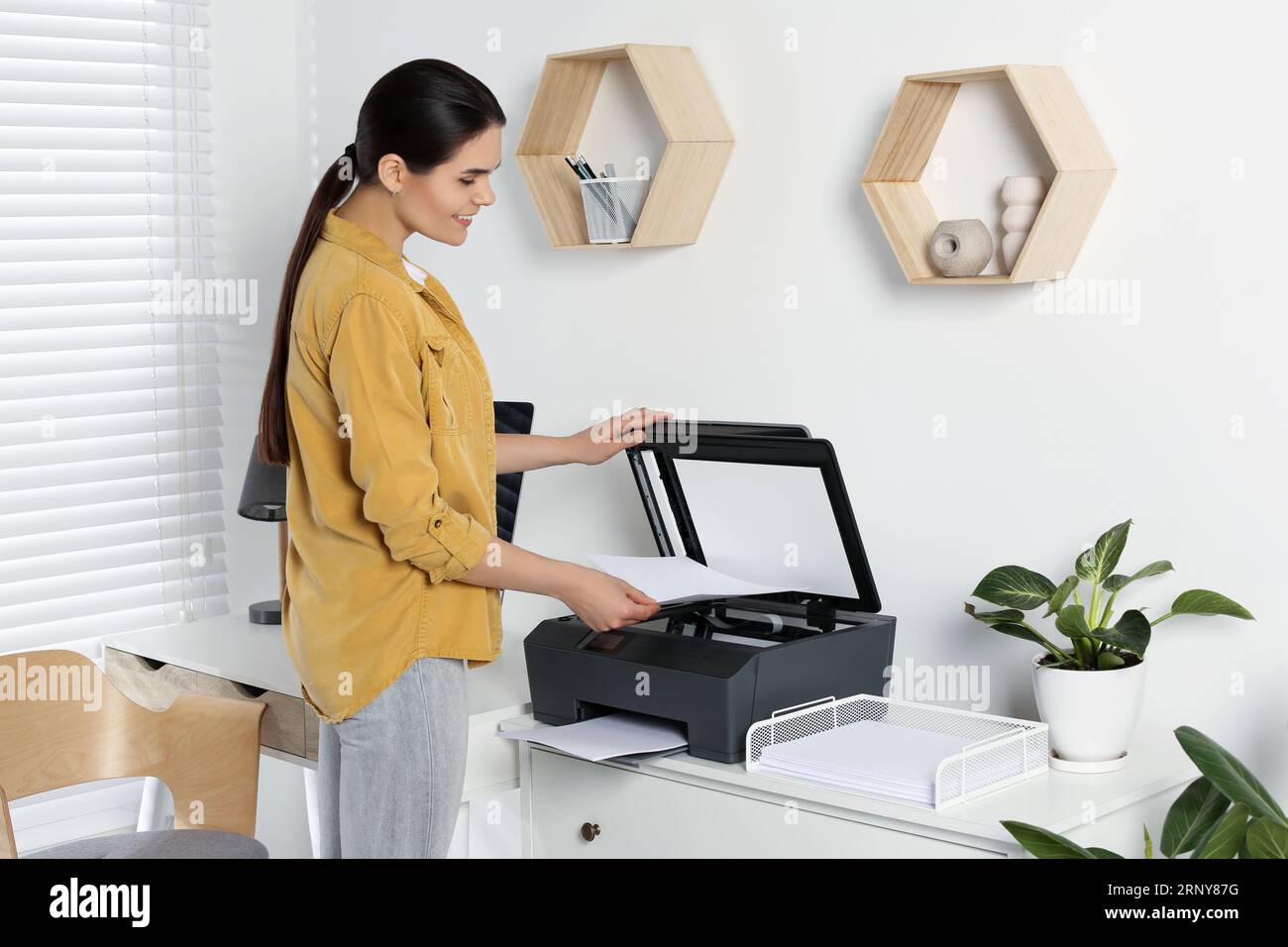 Person using black printer at home hi-res stock photography and images ...