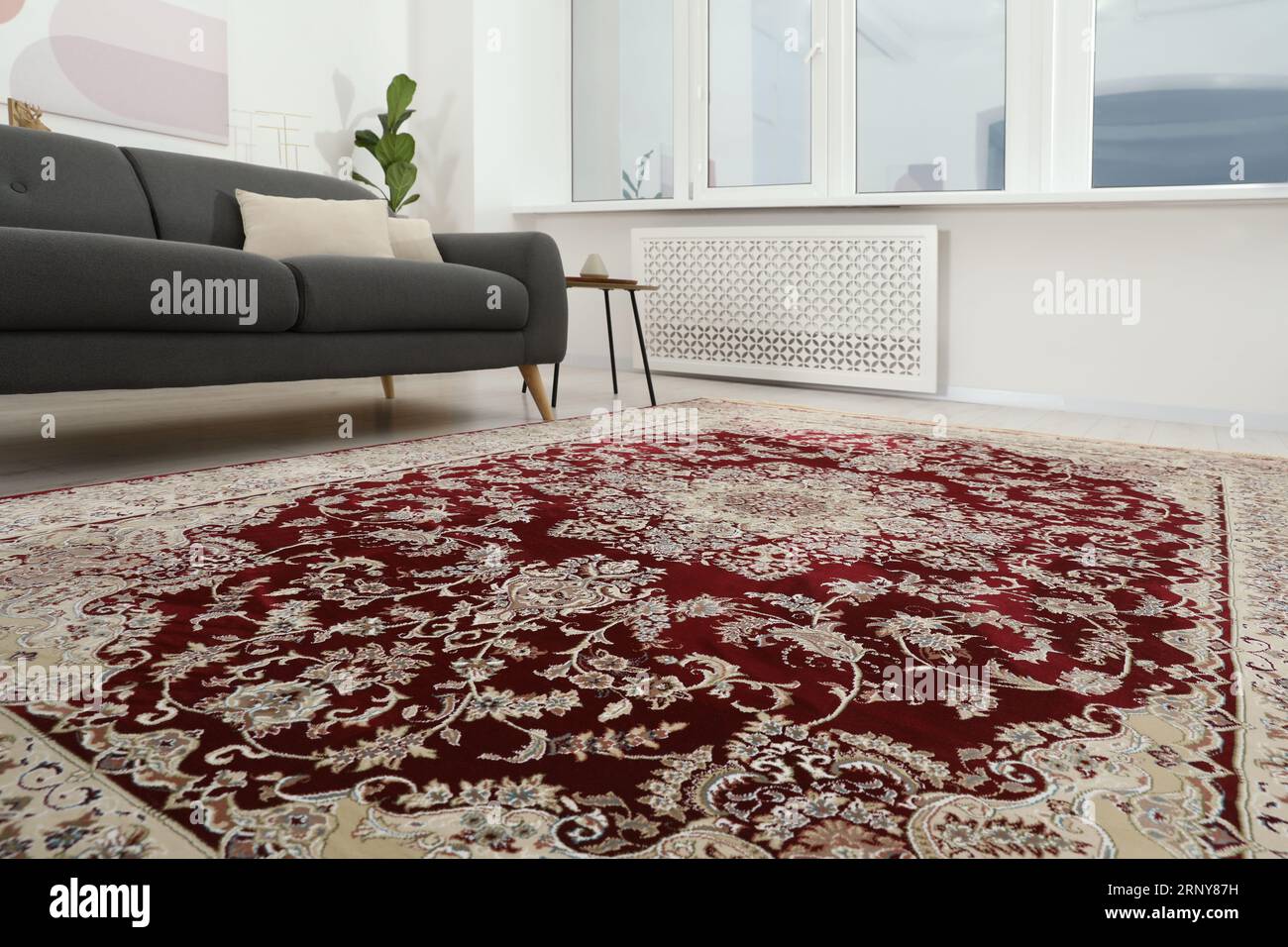 Cozy room interior with stylish furniture and soft carpet with ...