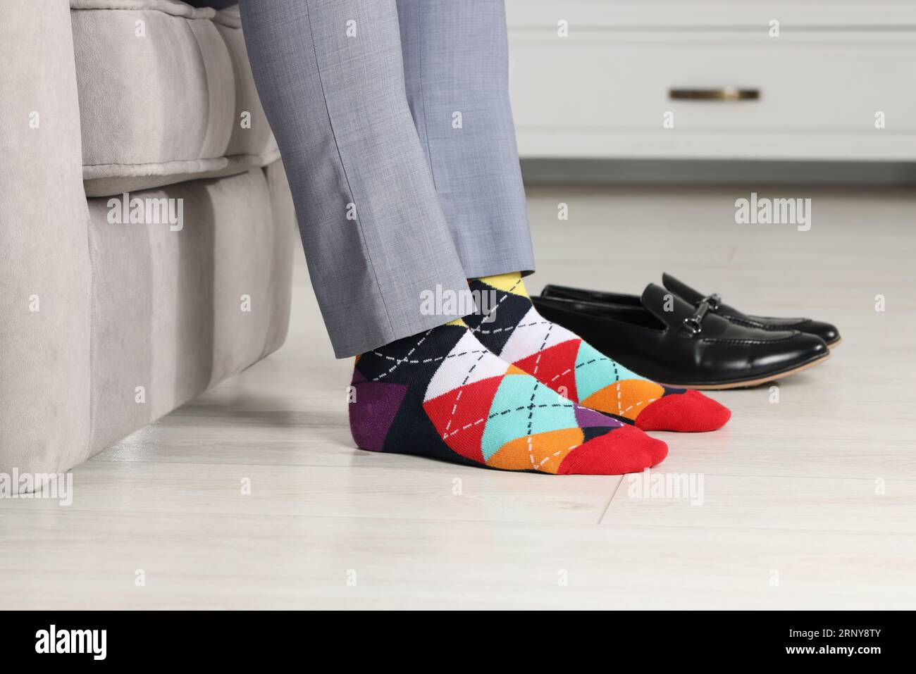 Man wearing colorful socks indoors, closeup view Stock Photo - Alamy