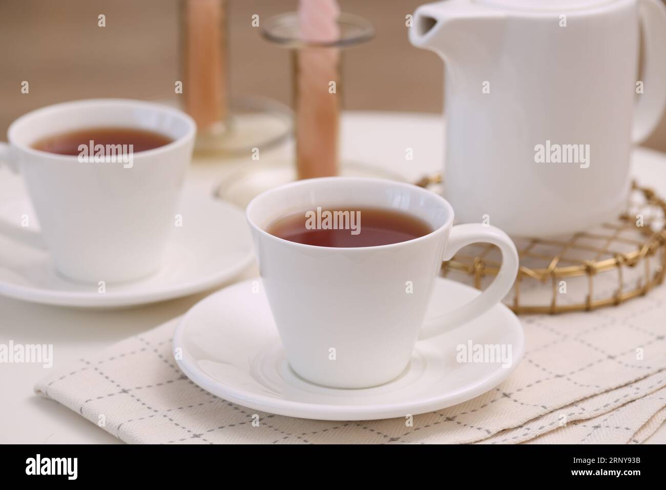 Cups of tea and teapot on white table Stock Photo - Alamy
