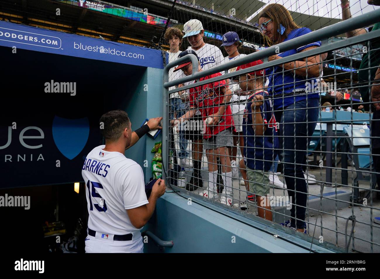 Los Angeles Dodgers catcher Austin Barnes takes a ball from a fan to ...
