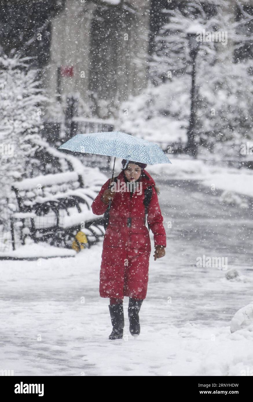 (180321) -- NEW YORK, March 21, 2018 -- A woman walks in snow at ...