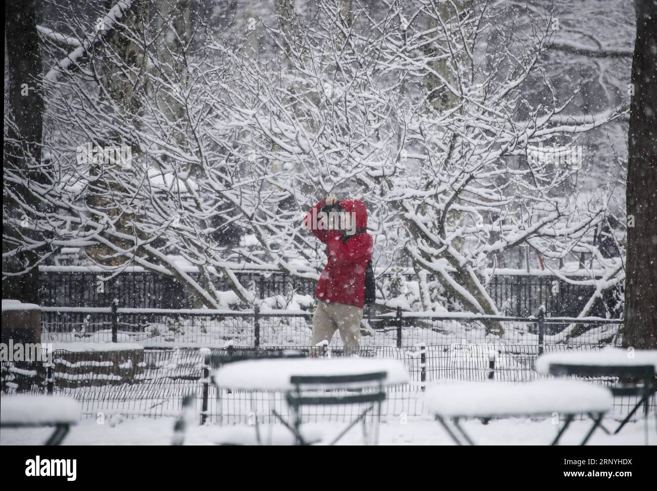 (180321) -- NEW YORK, March 21, 2018 -- A man takes photos in snow at ...
