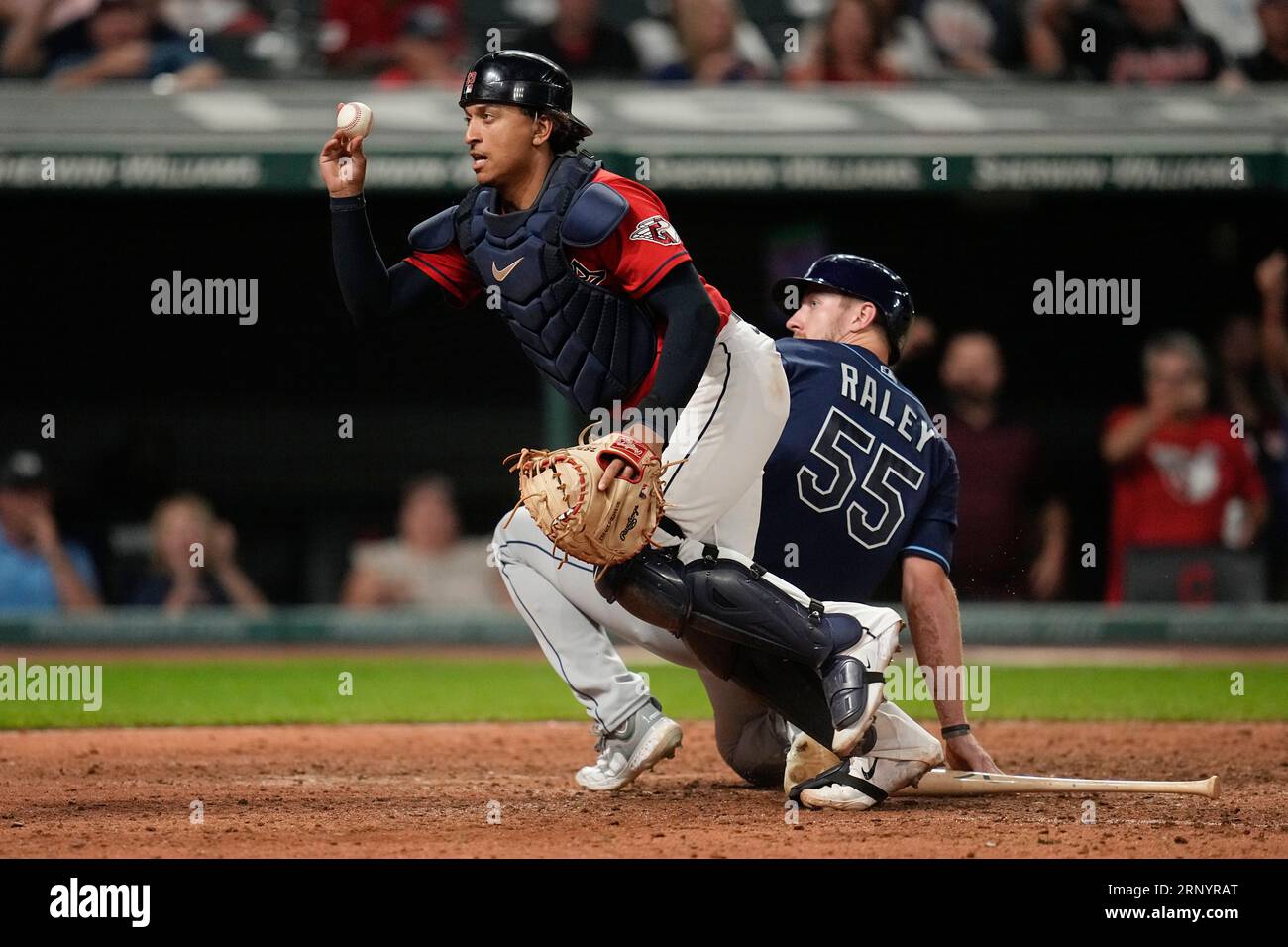 Cleveland Guardians catcher Bo Naylor, left, shows the ball to the ...