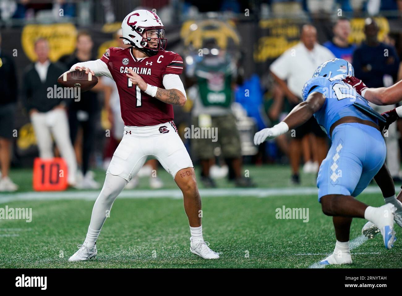 South Carolina quarterback Spencer Rattler, left, throws the ball ...