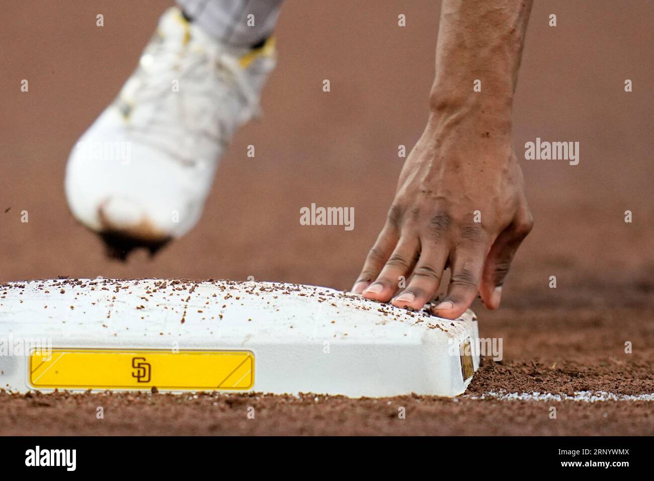 San Diego Padres' Jose Azocar touches first base, tagging up during the ...