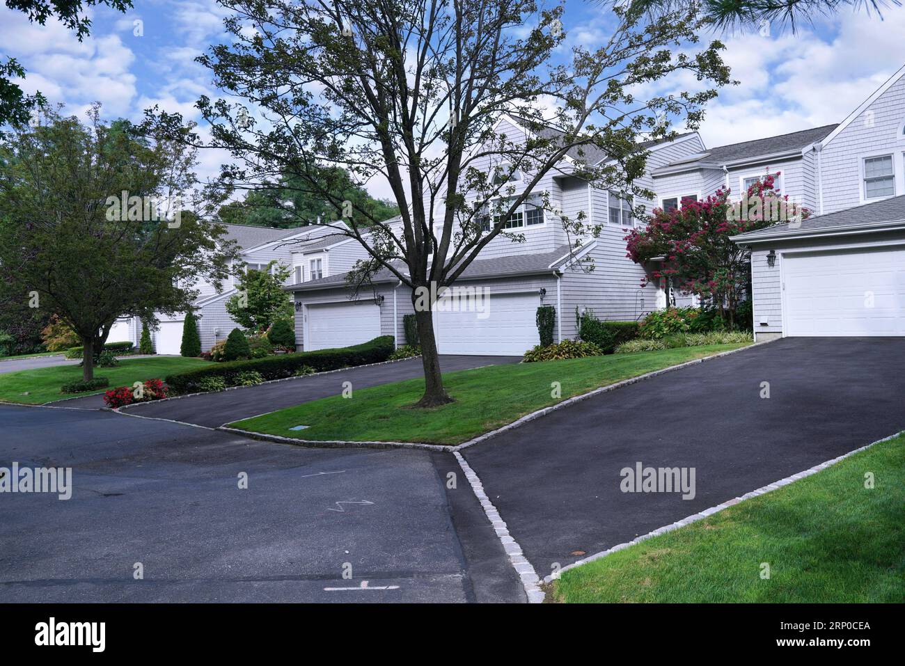 Suburban residential street, houses with two-car garage Stock Photo - Alamy