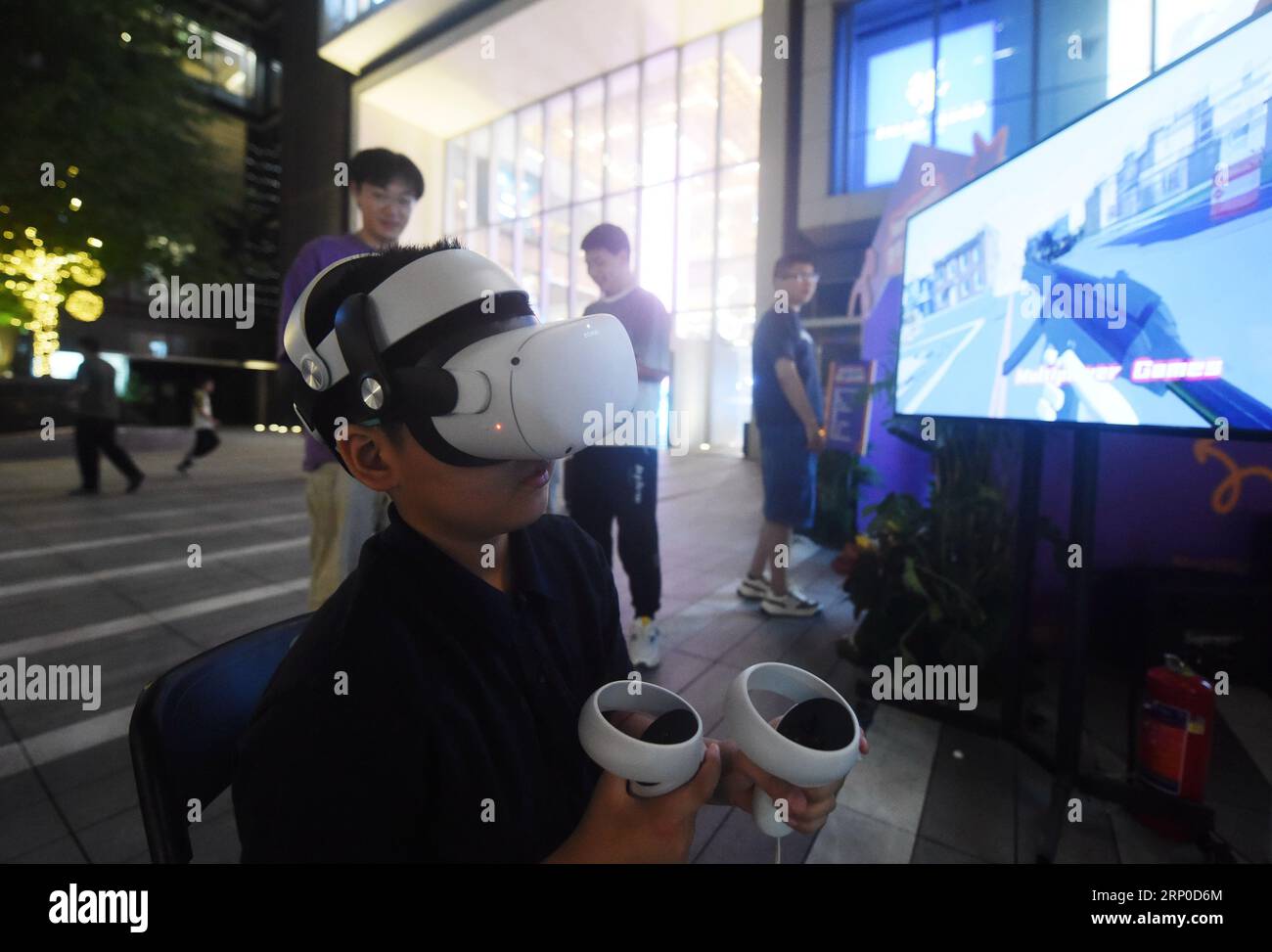 HANGZHOU, CHINA - SEPTEMBER 1, 2023 - A child experiences a VR game in ...