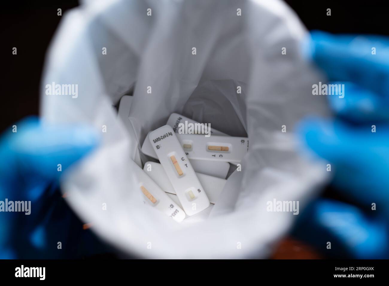 Medical staff disposing used Covid-19 antigen test kits Stock Photo - Alamy