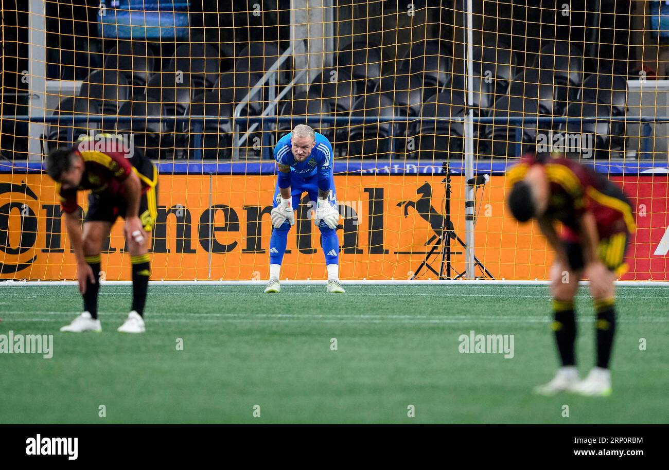 Seattle Sounders goalkeeper Stefan Frei, center, rests his hands on his ...