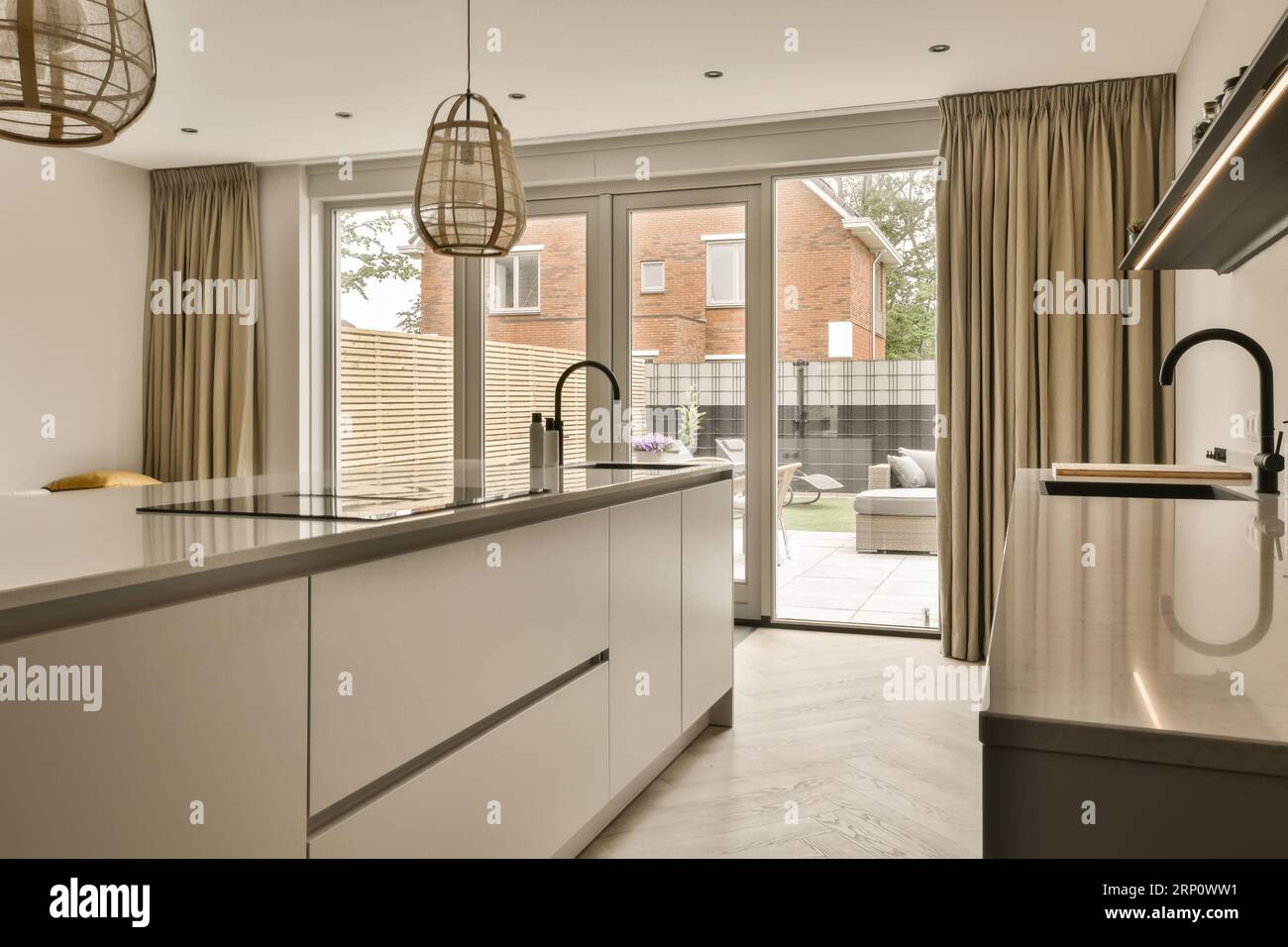a modern kitchen with an open door leading to the back yard and outdoor ...