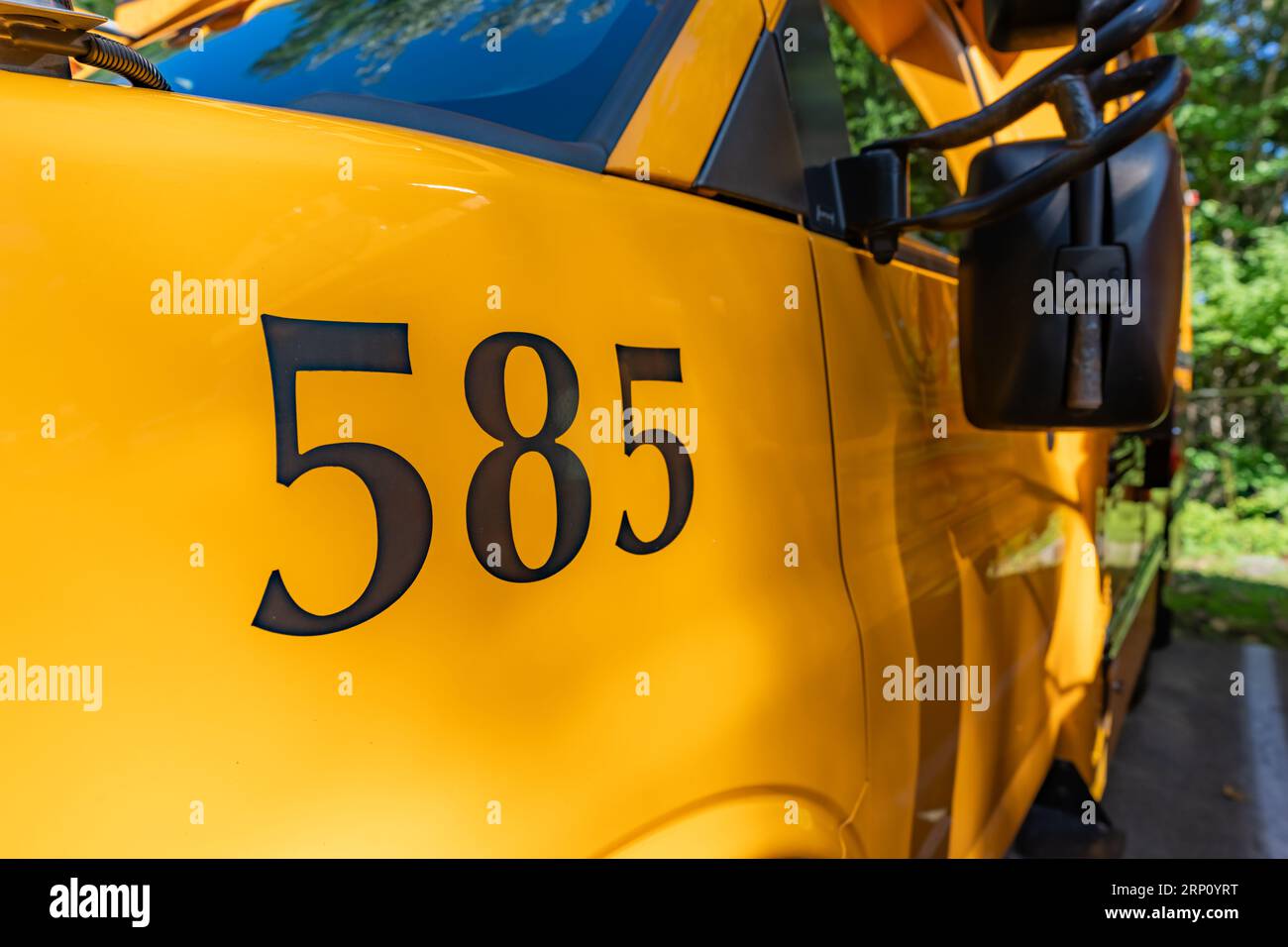 Side of a parked yellow school bus number 585 Stock Photo - Alamy