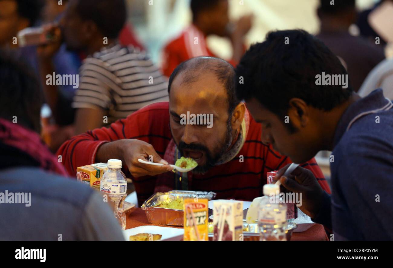 (180531) -- TRIPOLI, May 31, 2018 -- Illegal immigrants eat food in a ...